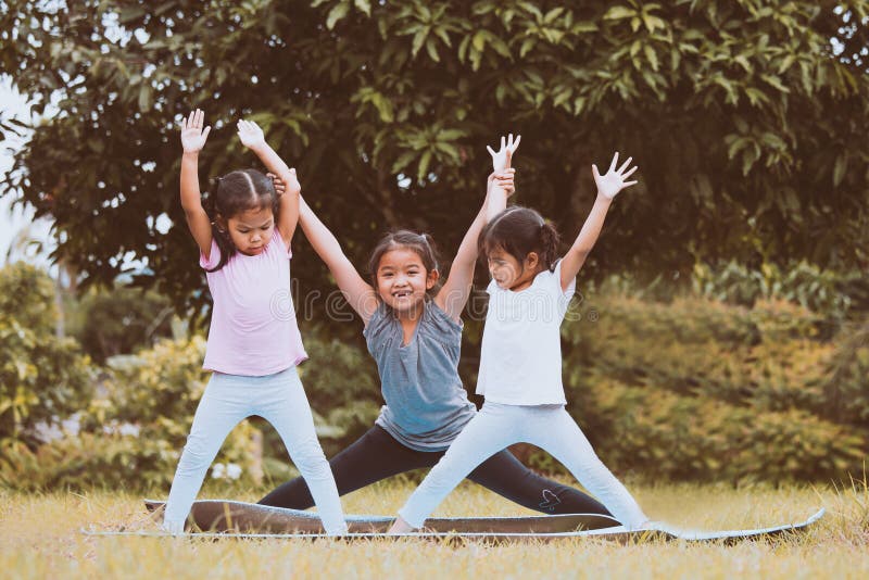 Happy Children Doing Exercise Together in the Park Stock Photo - Image ...