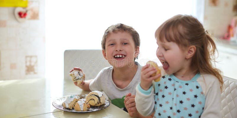 Happy Children Eat Pastries in the Bright Kitchen Stock Image - Image ...
