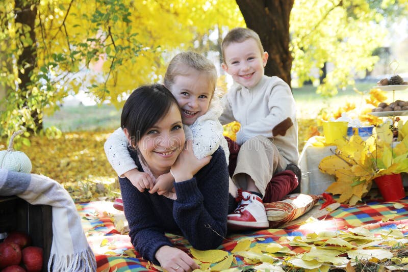 Happy Children Hugging Their Mother Under Autumn Trees Stock Photos ...