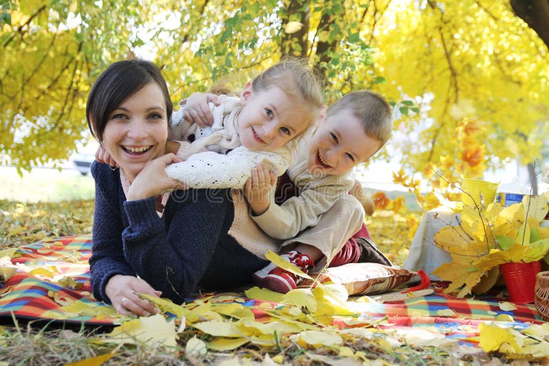 Happy Children Hugging Their Mother Under Autumn Trees Stock Photos ...