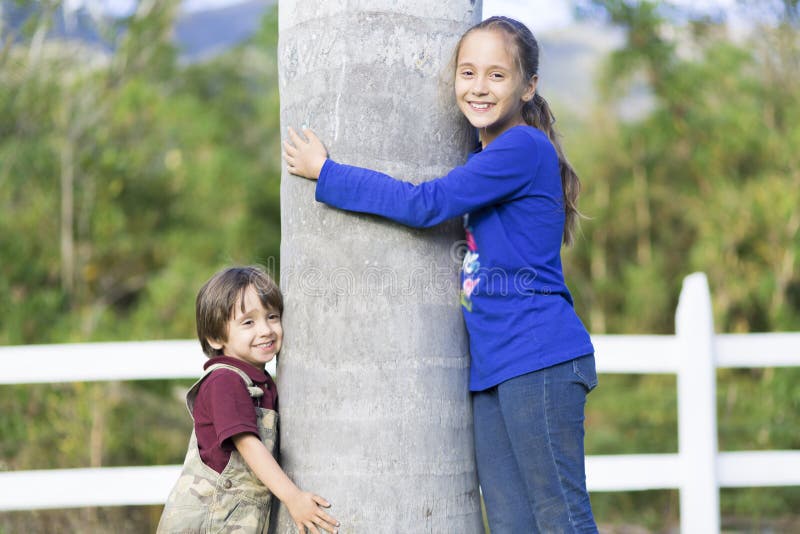 Happy Children Hugging a Tree Stock Photo - Image of ecology, kids ...