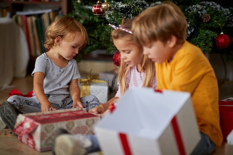 Happy Children Opening Christmas Gift at Home Stock Image - Image of ...