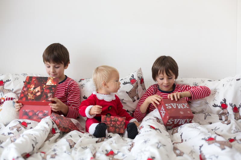 Happy Children, Opening Christmas Presents in Bed Stock Photo - Image ... Happy Children, Opening Christmas Presents in Bed Stock Photo - Image ...