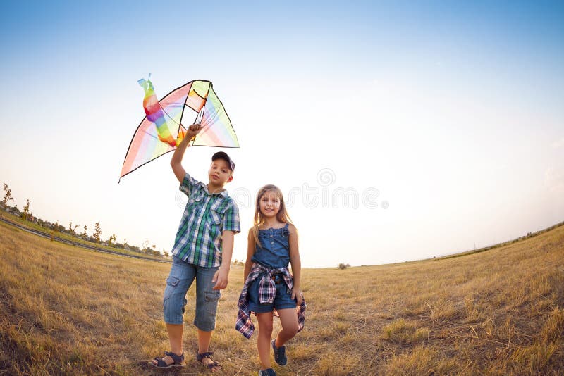 Happy Children Playing with Flying Kite on the Summer Field Stock Photo ...