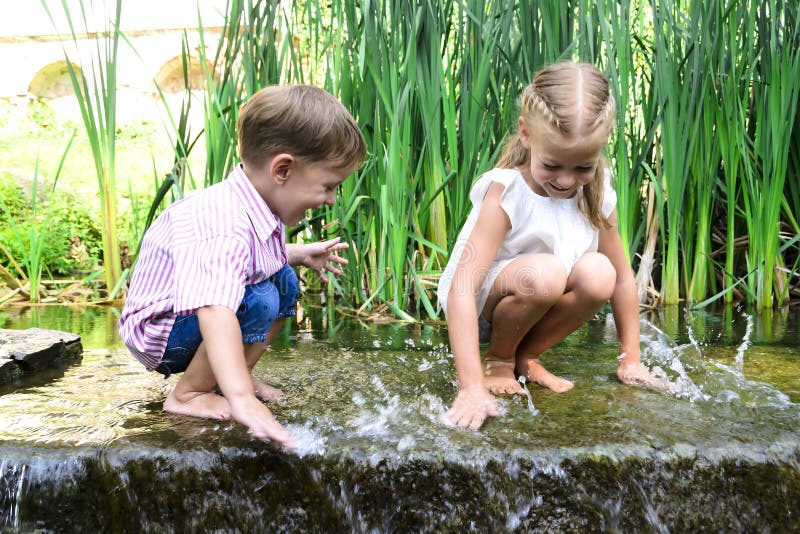 Happy Children Playing on Hot Summertime with Water in the Park Stock ...