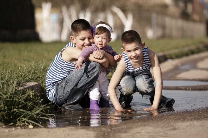 Happy Children Playing in the Puddle Stock Image - Image of countryside ...
