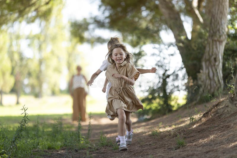 Children Joyfully Running through Sunny Park Stock Photo - Image of ...