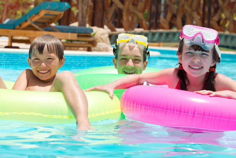 Happy children in pool stock photo. Image of colourful - 20340398