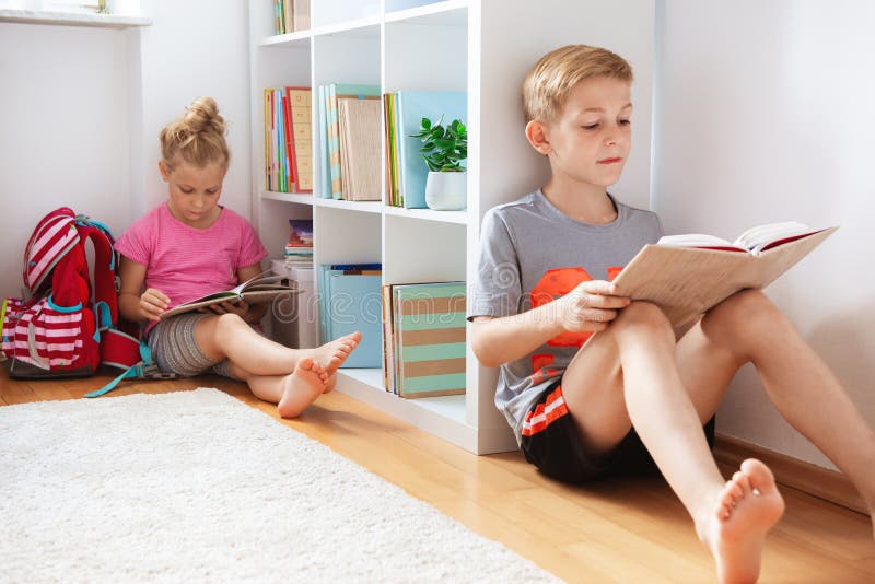 Happy Children Reading Books on the Floor at the School Library Stock ... Happy Children Reading Books on the Floor at the School Library Stock ...