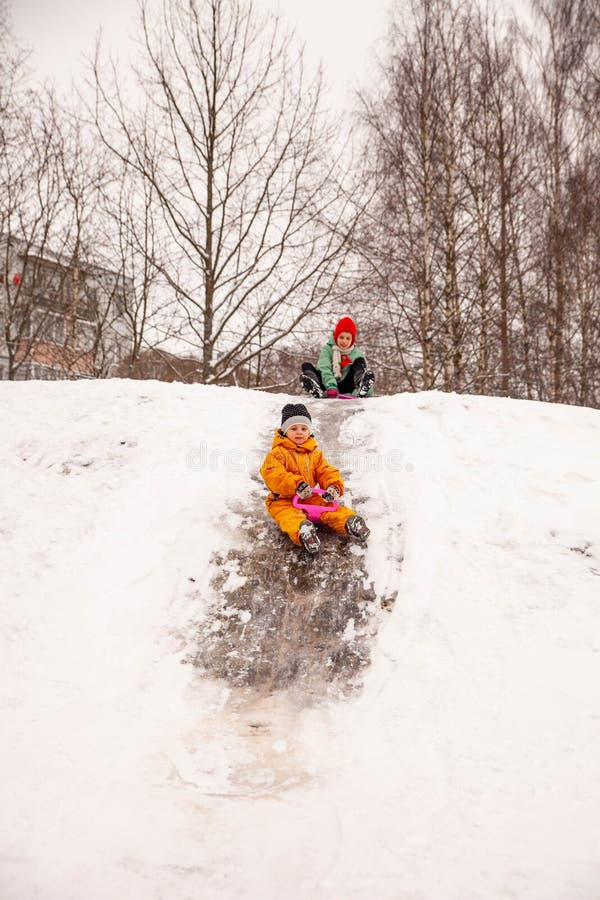 Happy Children Riding Down Ice Slide Stock Photo - Image of clothes ...