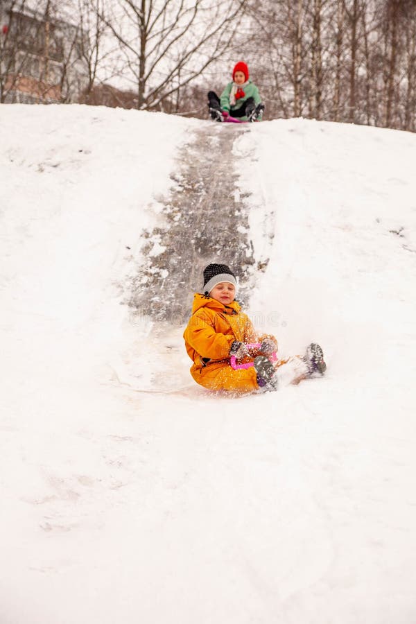 Happy Children Riding Down Ice Slide Stock Photo - Image of happiness ...