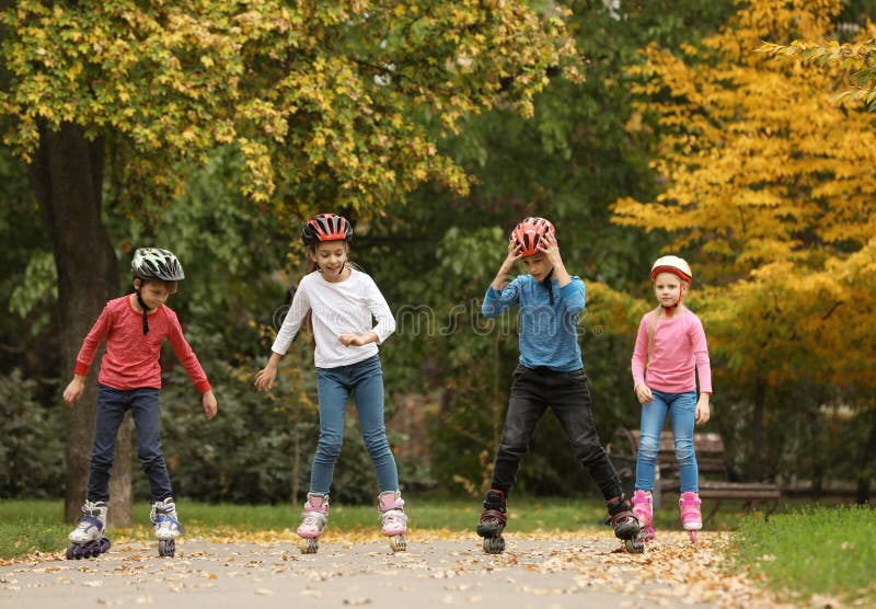 Happy Children Roller Skating in Park Stock Photo - Image of kids ...
