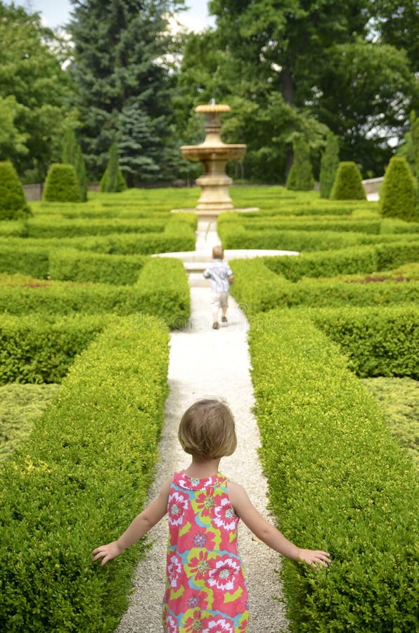 Happy Children Running through the Maze Stock Photo - Image of summer ...