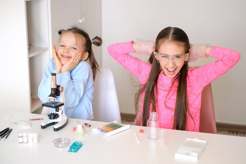 Happy Children at School Desk in Science School Examine Liquids and ...