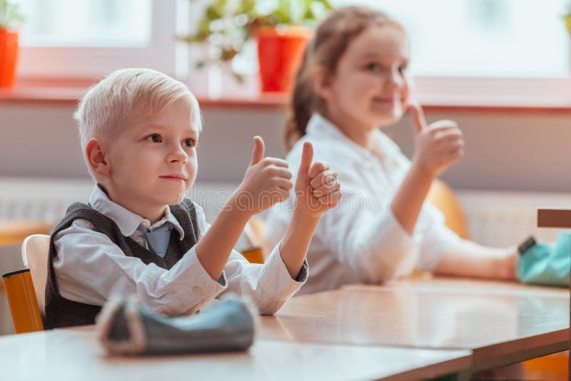 Children Sit Together at the Table during the First Physics Lesson in ...