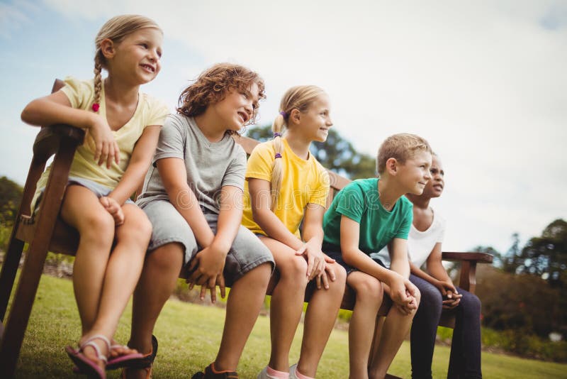 Happy Children Sitting on a Bench Stock Photo - Image of friend, bench ...