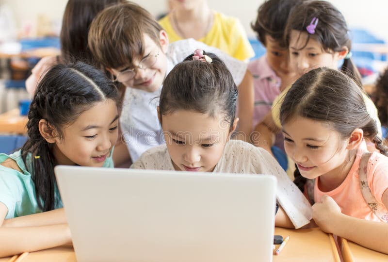 Happy Children Watching the Laptop in the Classroom Stock Photo - Image ...