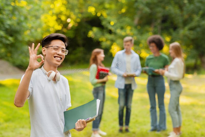Happy Chinese Student Guy Gesturing Ok while Posing Outdoors at Campus ...
