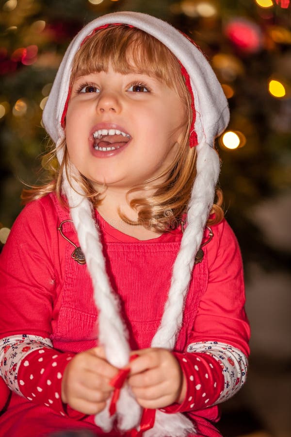 Christmas Girl in Front of Christmas Tree Stock Photo - Image of bokeh ...