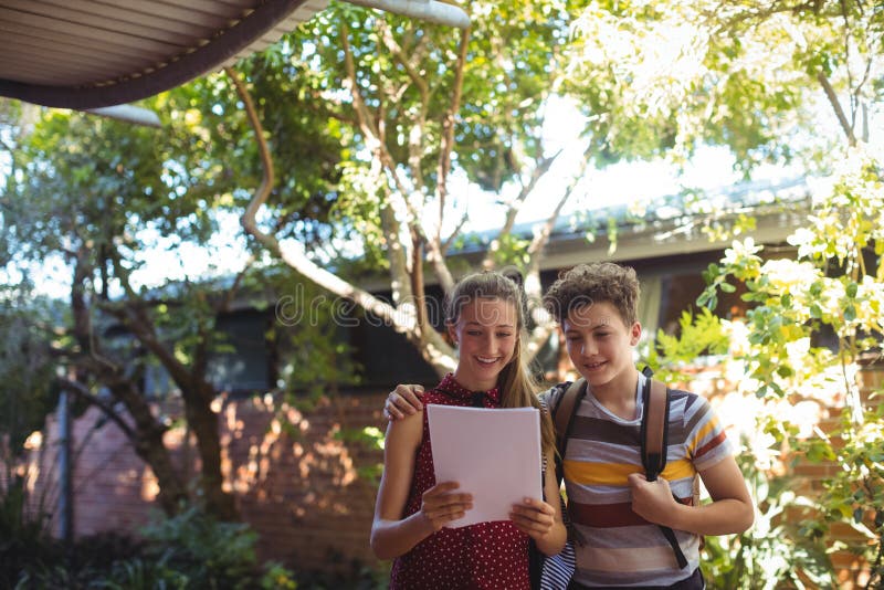 Happy Classmates Reading Book Stock Photo - Image of child, friendship ...