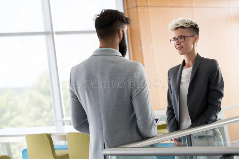 Happy Colleagues Casual Chat at the Office Stock Photo - Image of ...