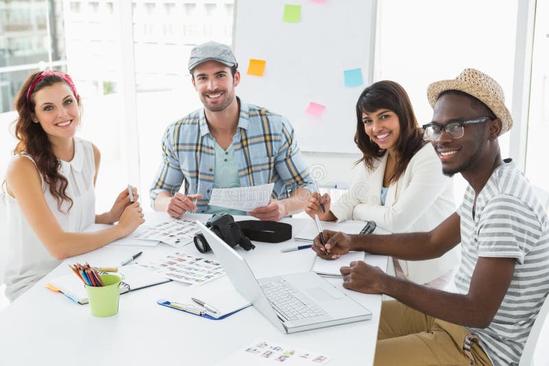 Happy Colleagues Sitting and Looking at Camera Stock Photo - Image of ...