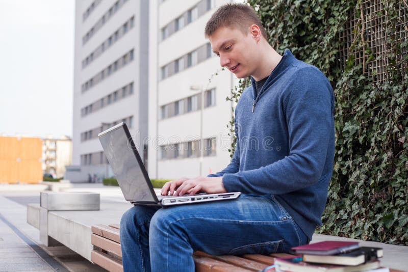 Happy College Student Learning Over the Bench with Laptop. Stock Image ...