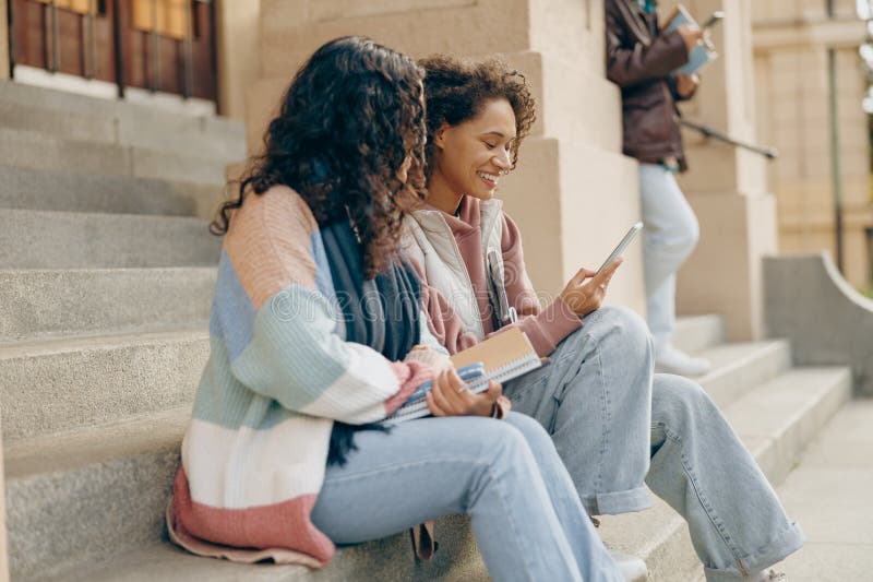 Happy College Students Having Fun Using Mobile Phone Together in Campus ...
