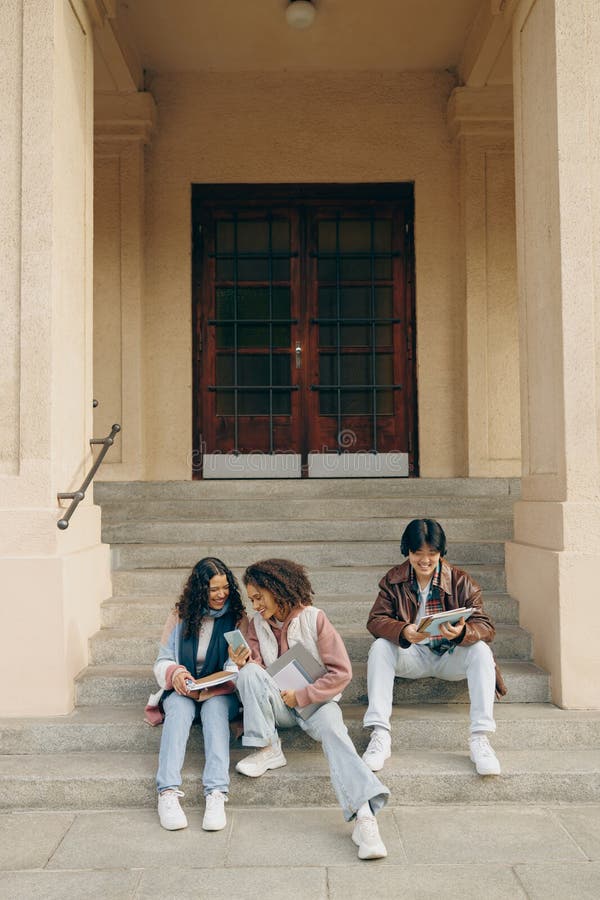 Happy College Students Having Fun Using Mobile Phone Together in Campus ...