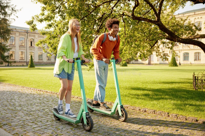 Happy Company of Students Using Electric Scooter Vehicles Stock Image ...