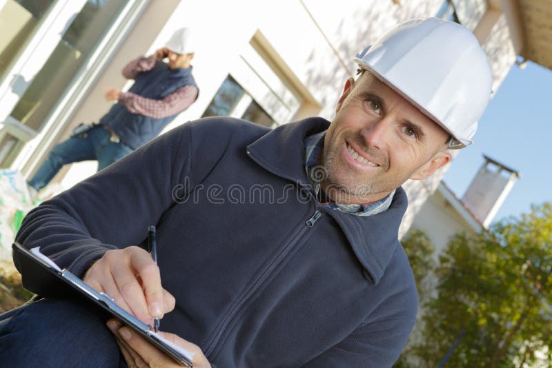 Happy Confident Builder Writing and Using Clipboard Stock Photo - Image ...