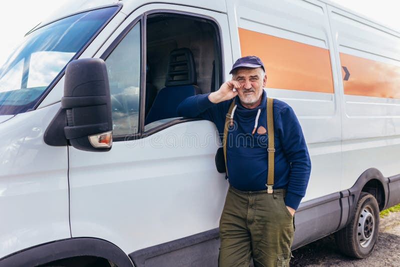 Confident Male Driver Standing in Front on His Van and Looking at ...