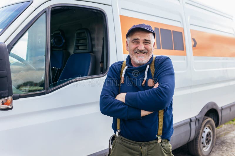 Confident Male Driver Standing in Front on His Van and Looking at ...