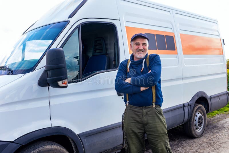 Mature Male Driver Standing in Front on His Van and Looking at Camera ...