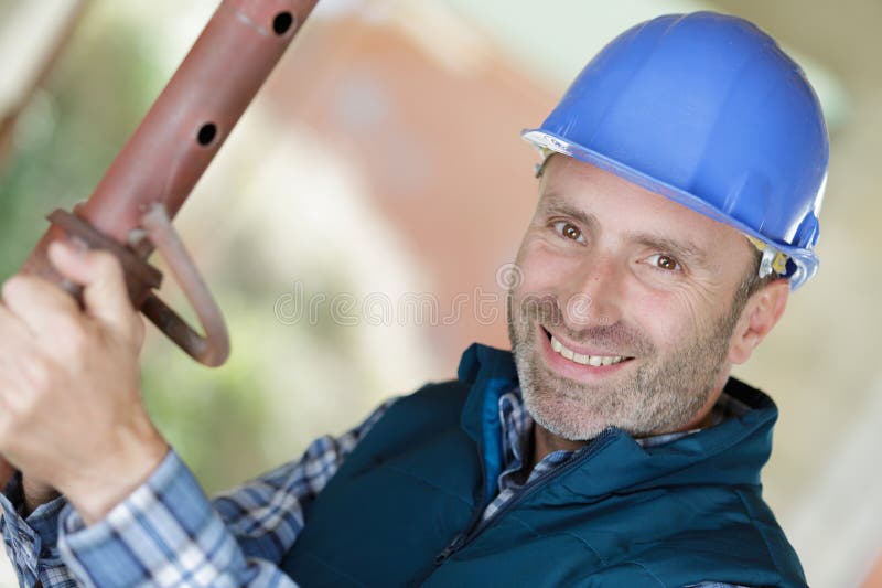 Happy Construction Worker on Site Holding Pipe Stock Image - Image of ...
