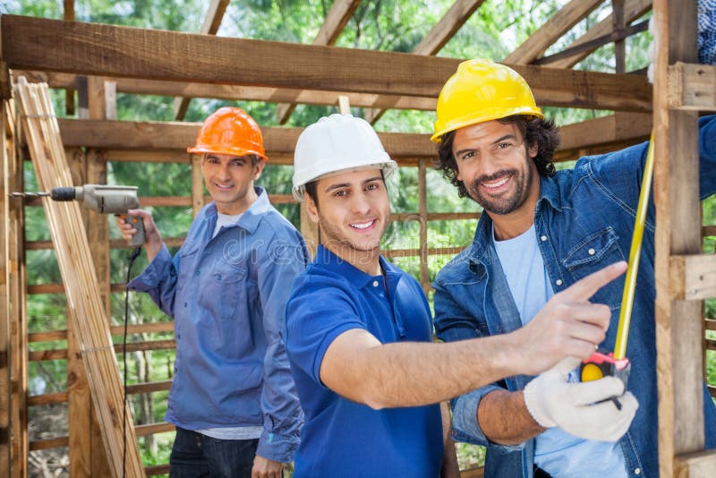 Happy Construction Workers Working in Wooden Cabin Stock Image - Image ...