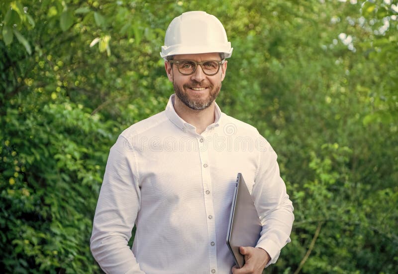 Happy Constructor Man in Hardhat Holding Laptop Outdoors Stock Photo ...