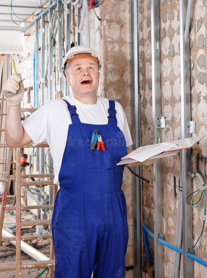 Happy Contractor Pointing Pen Up while Planning Building Works, Having ...