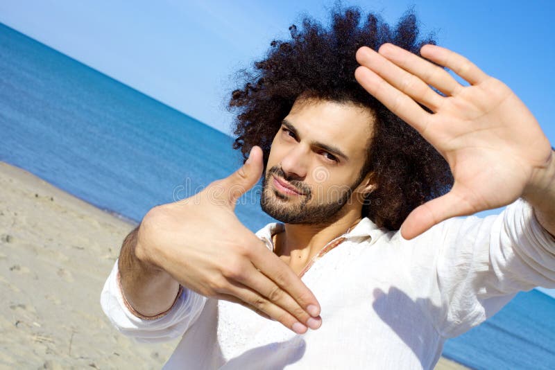 Happy Cool Man Playing with Camera on the Beach Posing Stock Photo ...