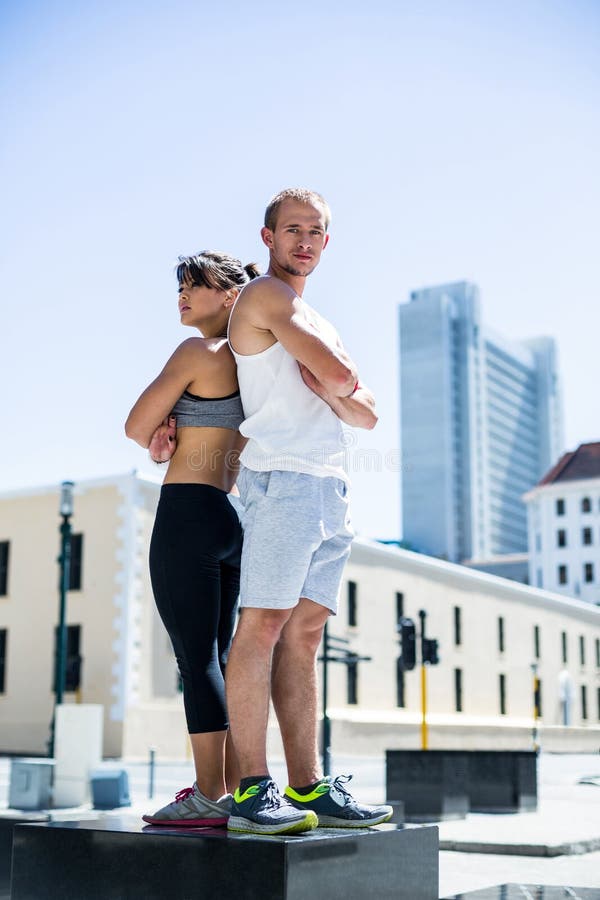 Happy couple back to back stock image. Image of cityscape - 56809413