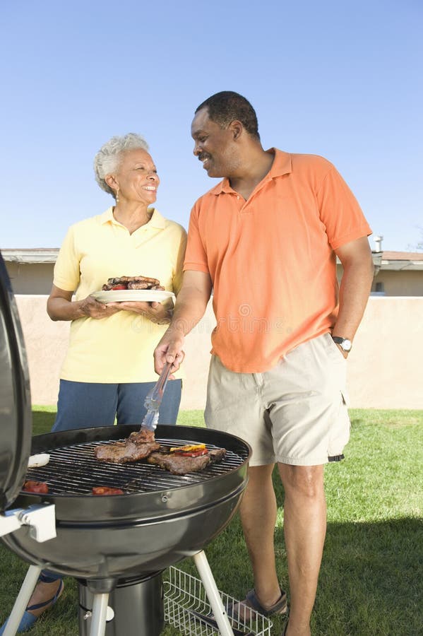 Happy Couple Barbecuing in Lawn Stock Image - Image of black, domestic ...