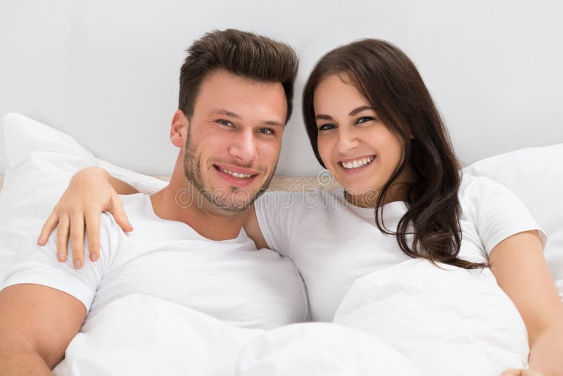 Happy couple on bed stock photo. Image of cute, couple - 55346212