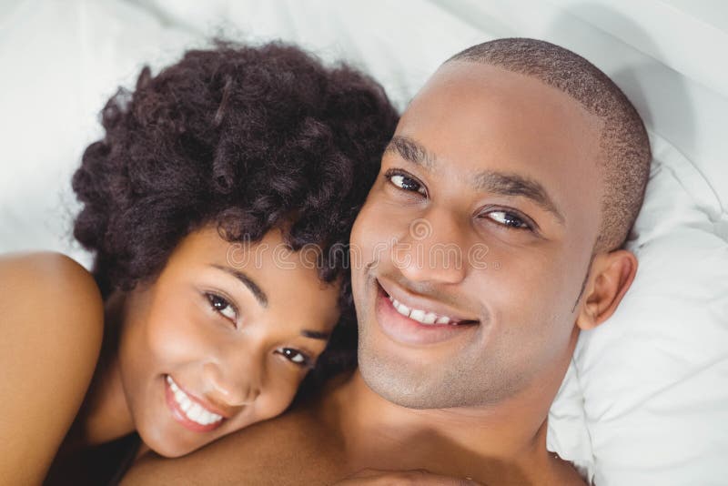 Happy Couple on Bed Smiling at the Camera Stock Photo - Image of couple ...