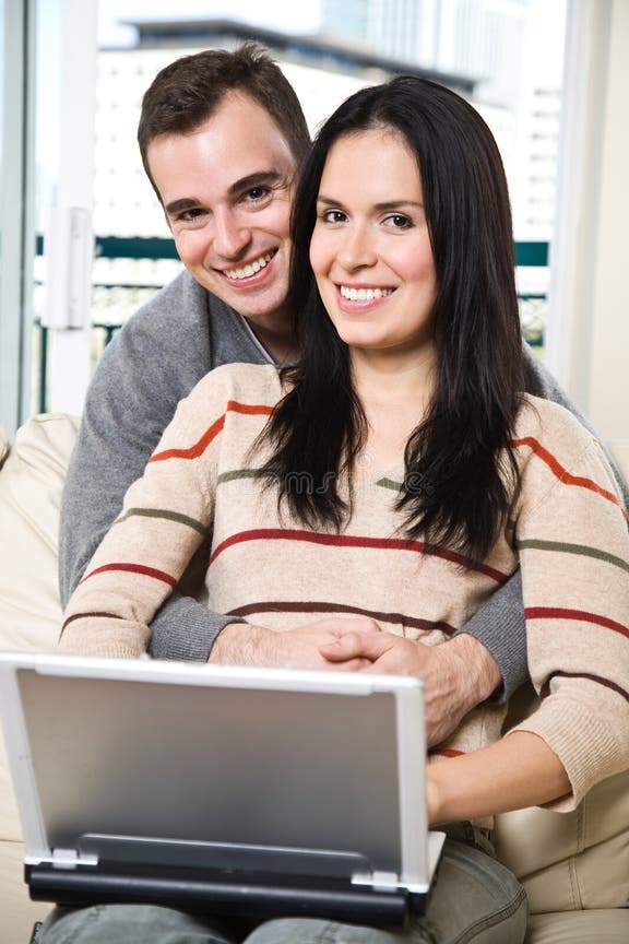 Happy Couple Browsing Internet at Home Stock Photo - Image of hispanic ...