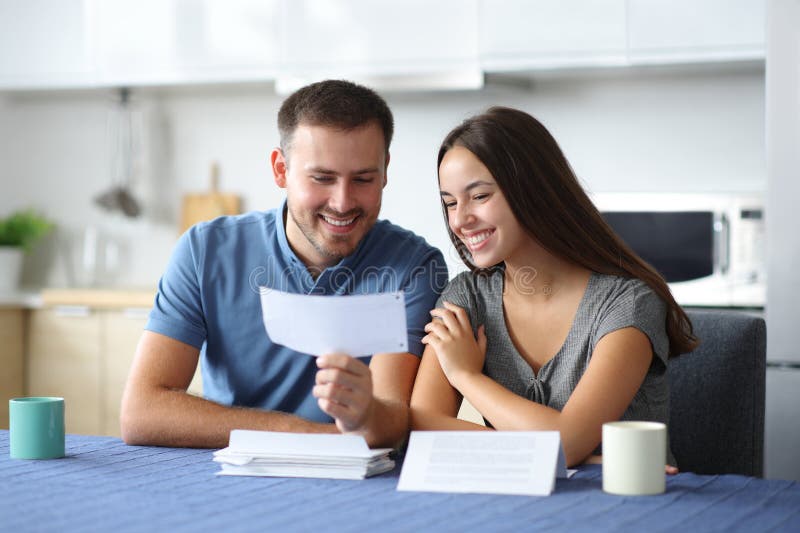 Happy Couple Checking Bank Statement in the Kitchen Stock Photo - Image ...