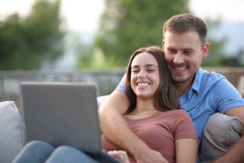 Happy Couple Checking Personal Computer in a Terrace Stock Photo ...