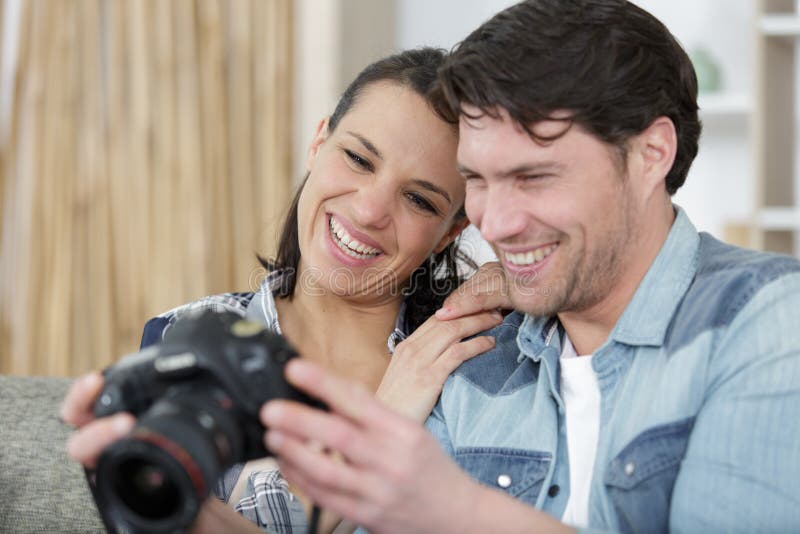 Happy Couple Checks Photos on Photos Camera Stock Photo - Image of ...