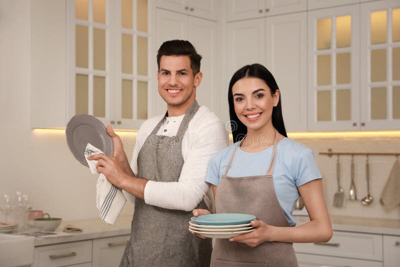 Happy Couple with Clean Dishes in Kitchen Stock Photo - Image of clean ...