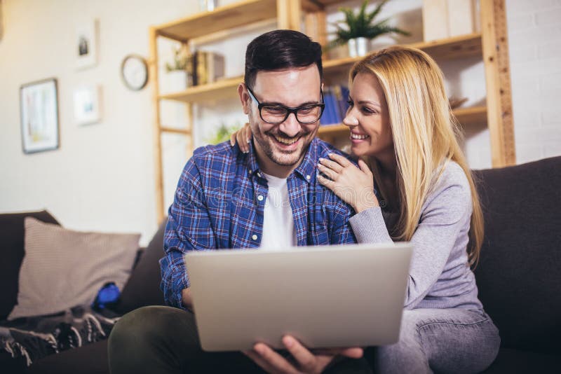 Joyful Couple Relax and Work on Laptop Computer at Modern Living Room ...