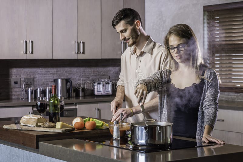 Happy Couple Cooking a Meal in the Kitchen Flirting Bonding Stock Photo ...